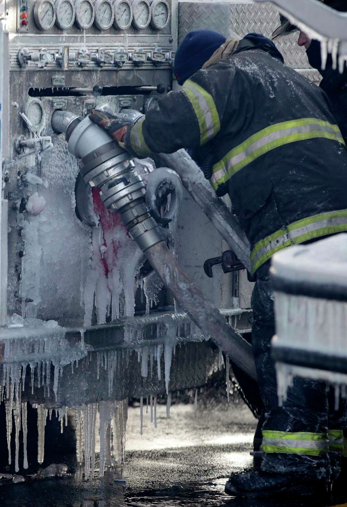 Firefighters battle the flames and the ice