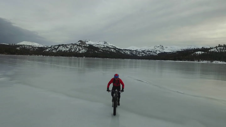 Video of a guy riding a bike across a frozen Caples Lake is surreal