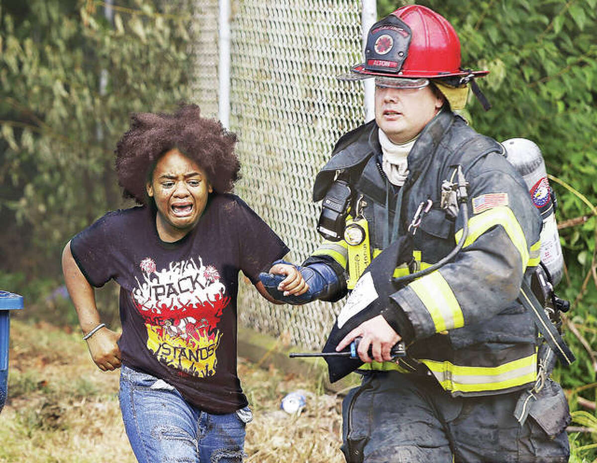 Alton firefighters rescue girl, 13, from basement of burning home