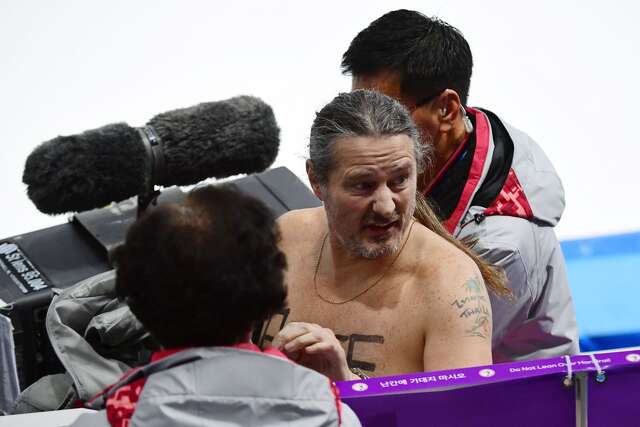 Tutu-clad streaker strips down on Olympic stadium ice, falls hard