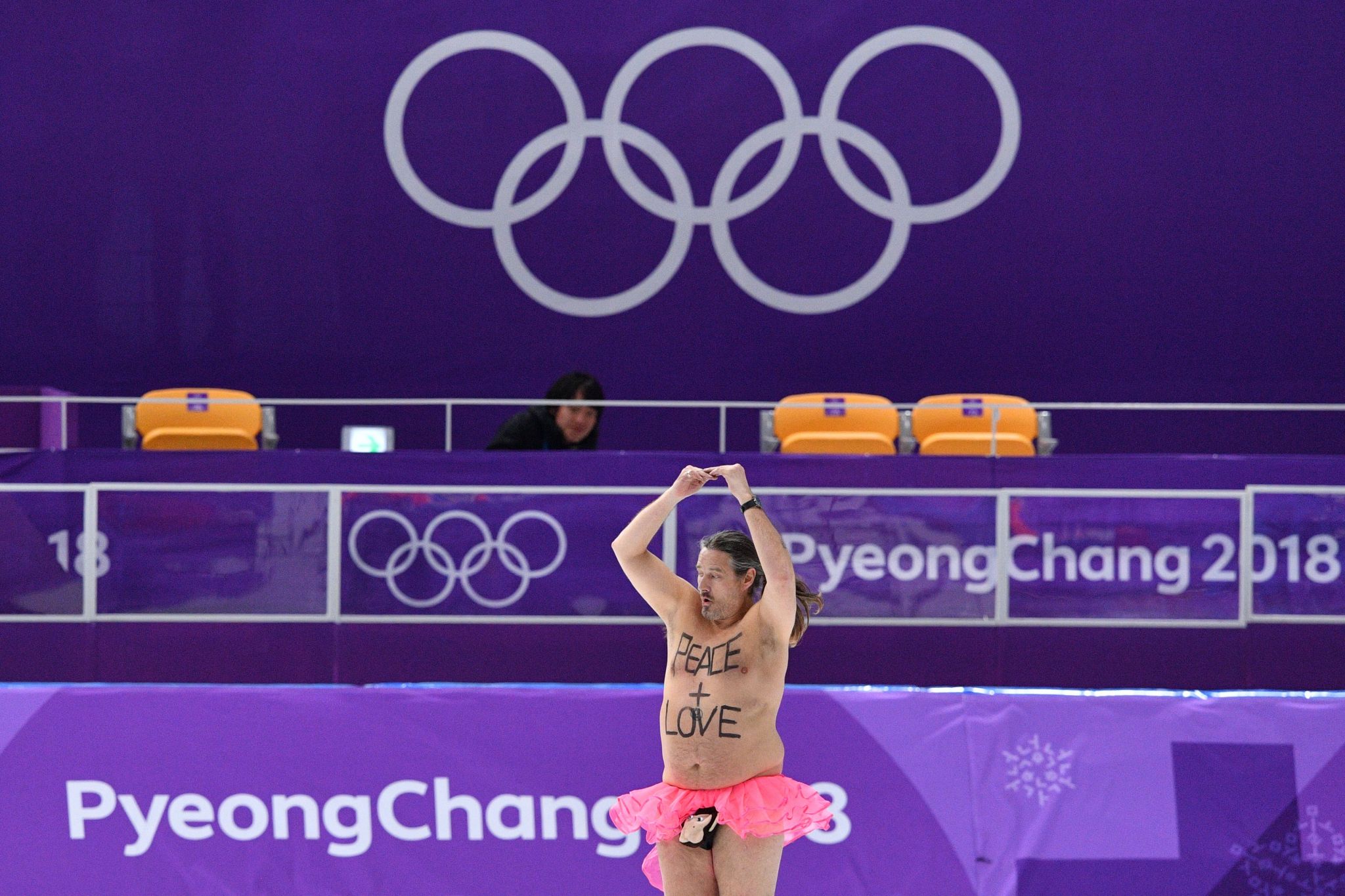 Tutu-clad streaker strips down on Olympic stadium ice, falls hard