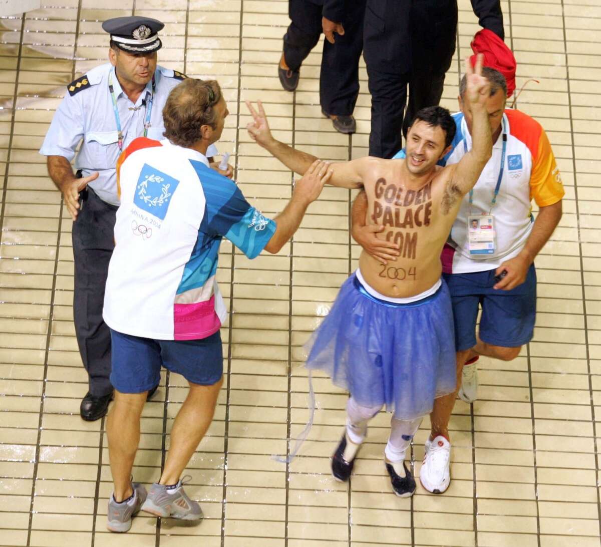 Tutu-clad streaker strips down on Olympic stadium ice, falls hard