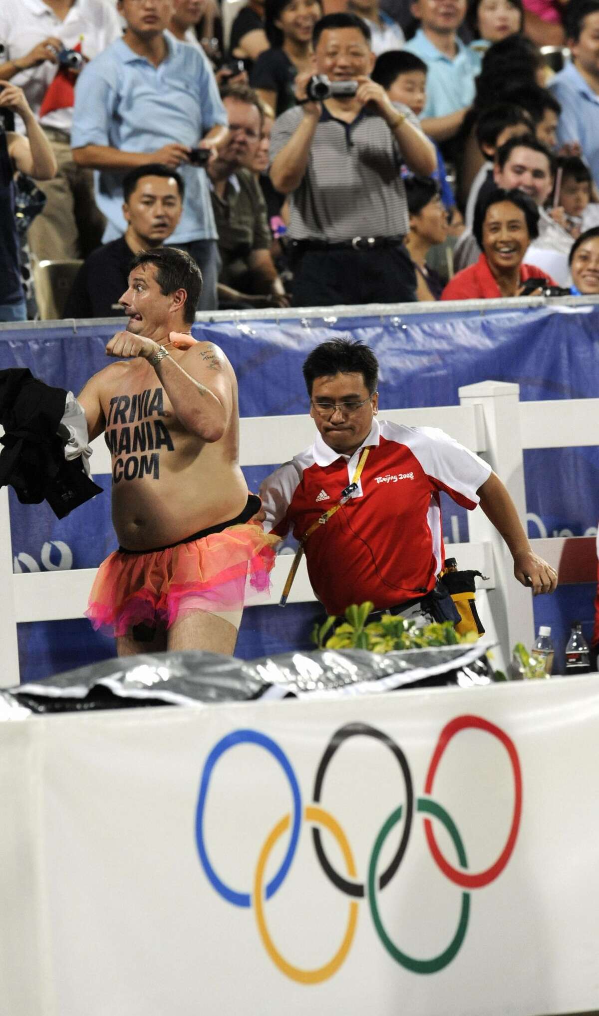 Tutu-clad streaker strips down on Olympic stadium ice, falls hard