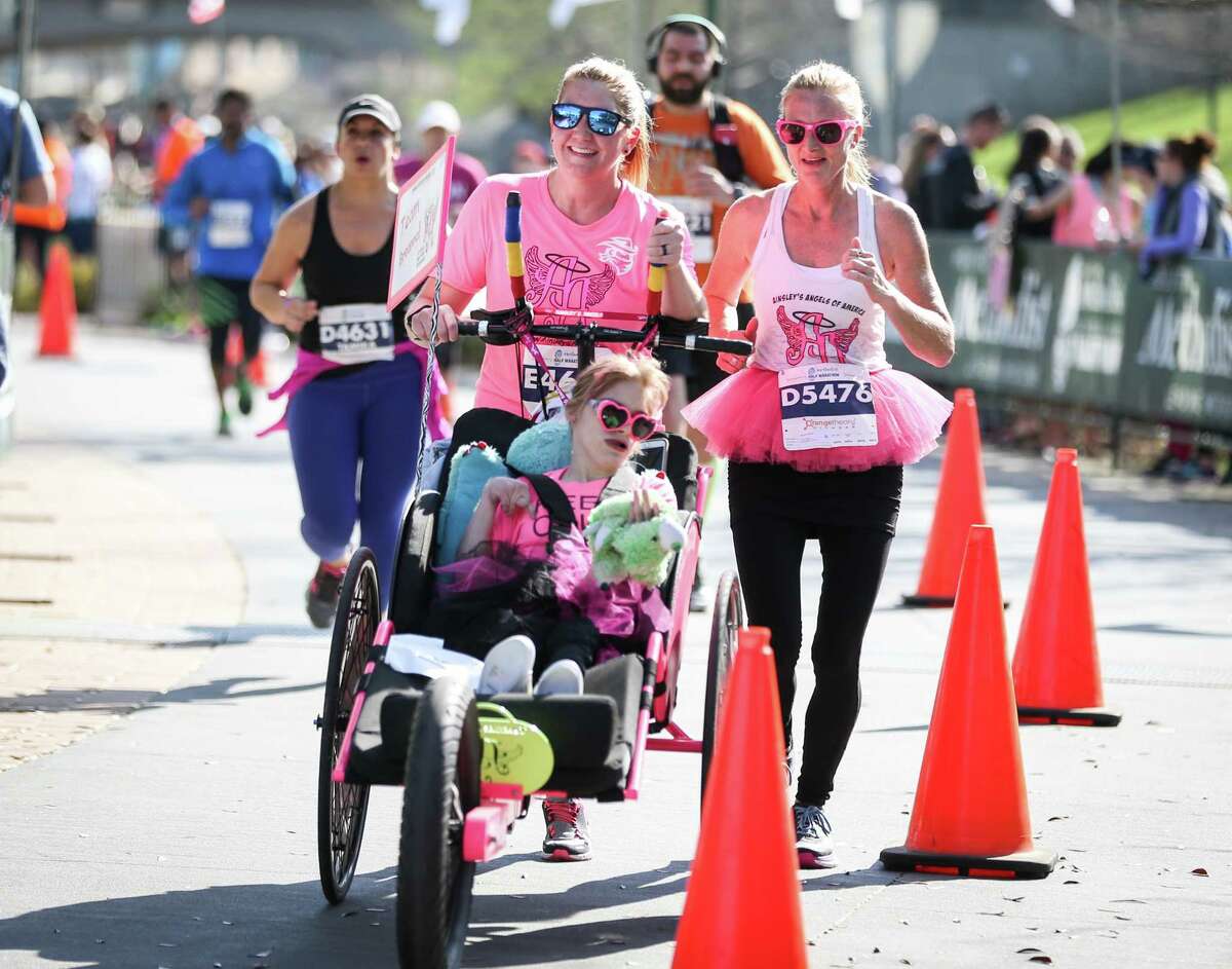 Thousands stride across the finish line of The Woodlands Marathon
