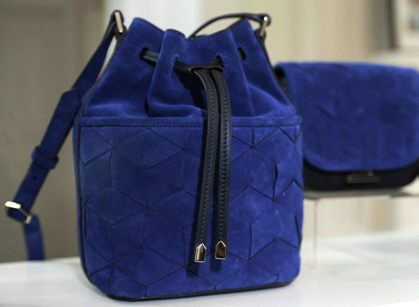 China ‘sneak peeks’ dealing aces for Norwalk bag designer