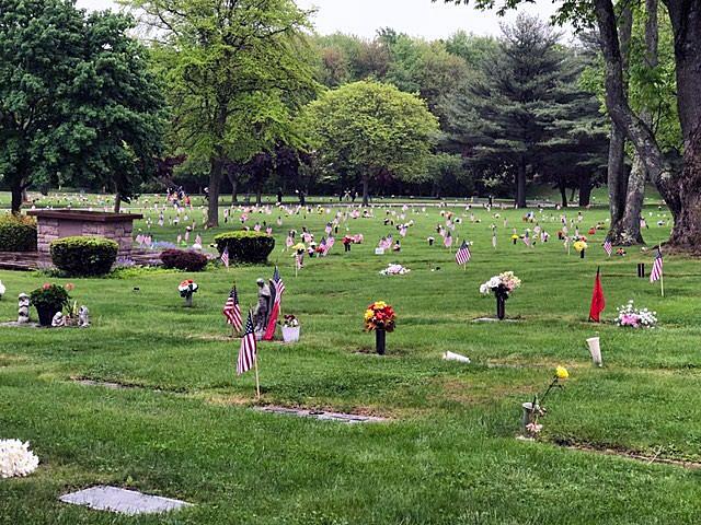 Trumbull first responders place flags on graves