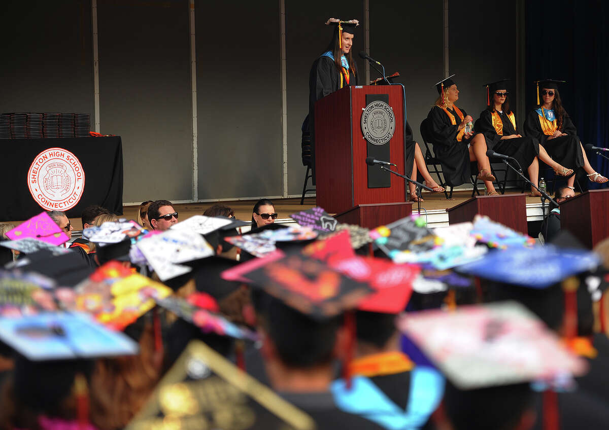 Shelton graduates brave dust, dirt to make their last official act on ...