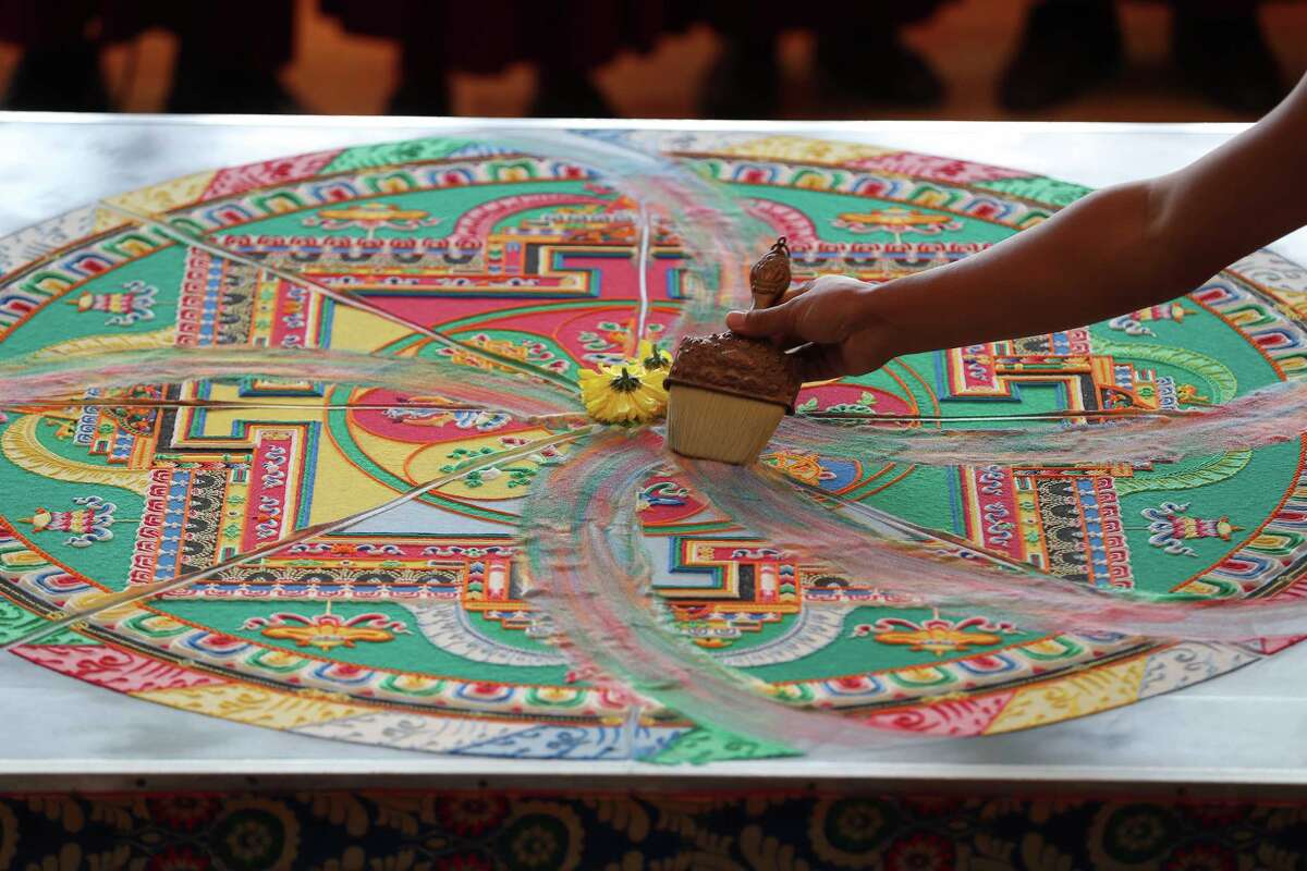 Tibetan Buddhist monks dismantle a mandala at Asia Society Texas Center ...