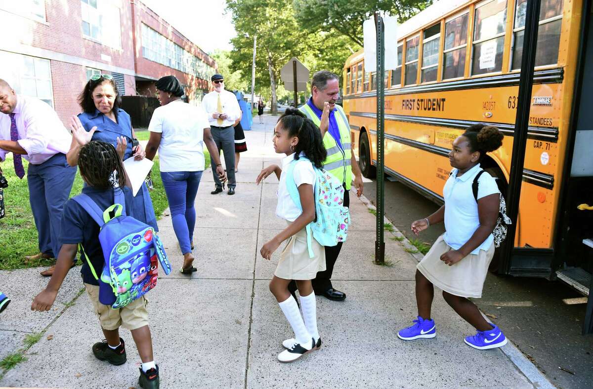 New Haven students back in school, high fives abound