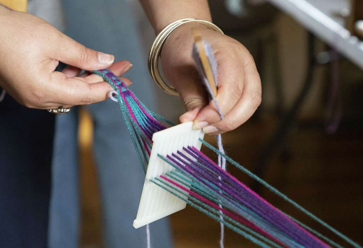 Visitors enjoy learning about hand weaving at San Antonio’s Mission Espada