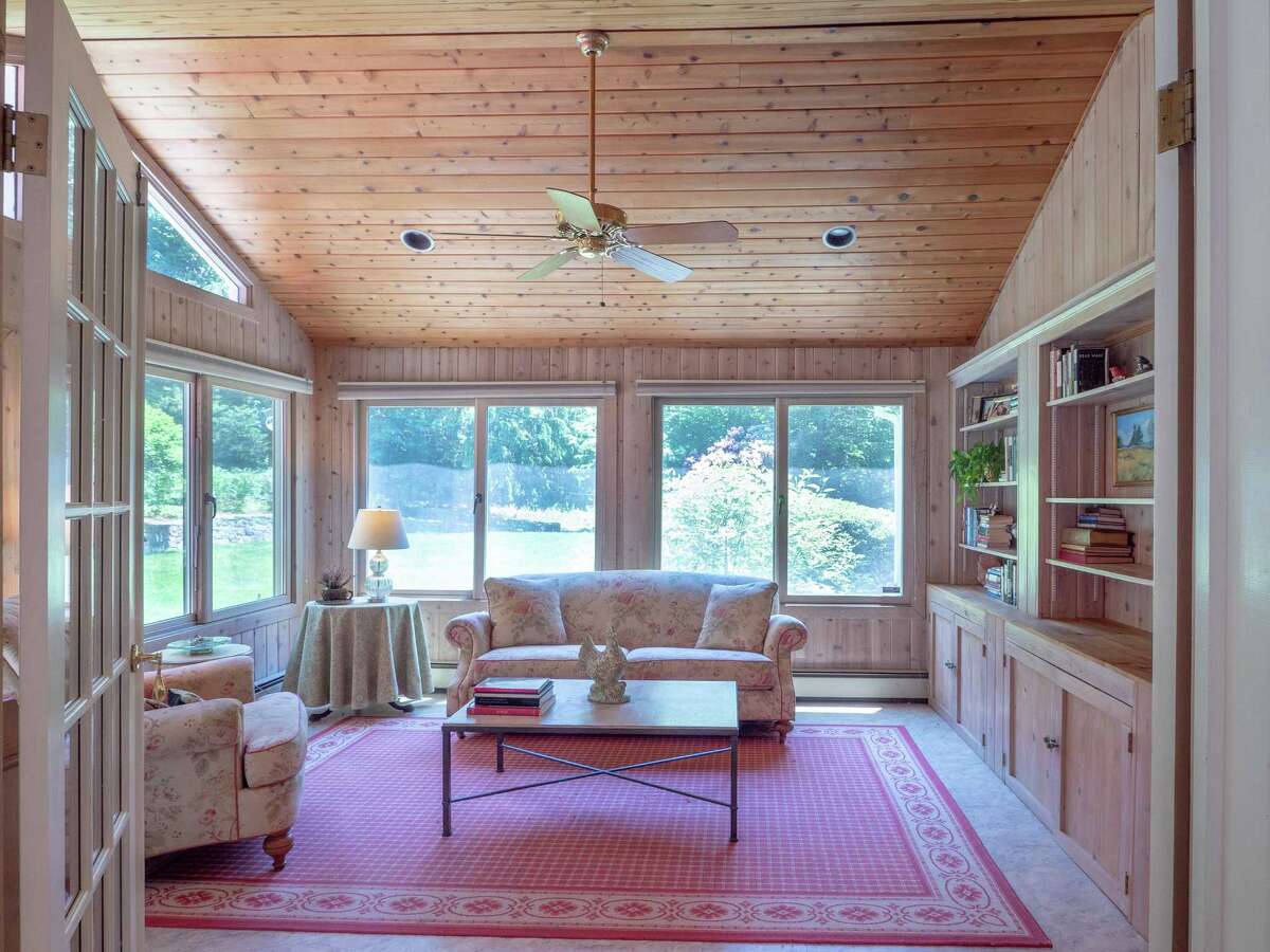 Colonial features front porch, sunroom on a 2.27-acre lot