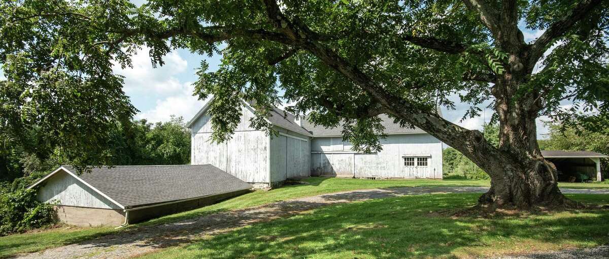 New England farmhouse a classic, outhouse and all
