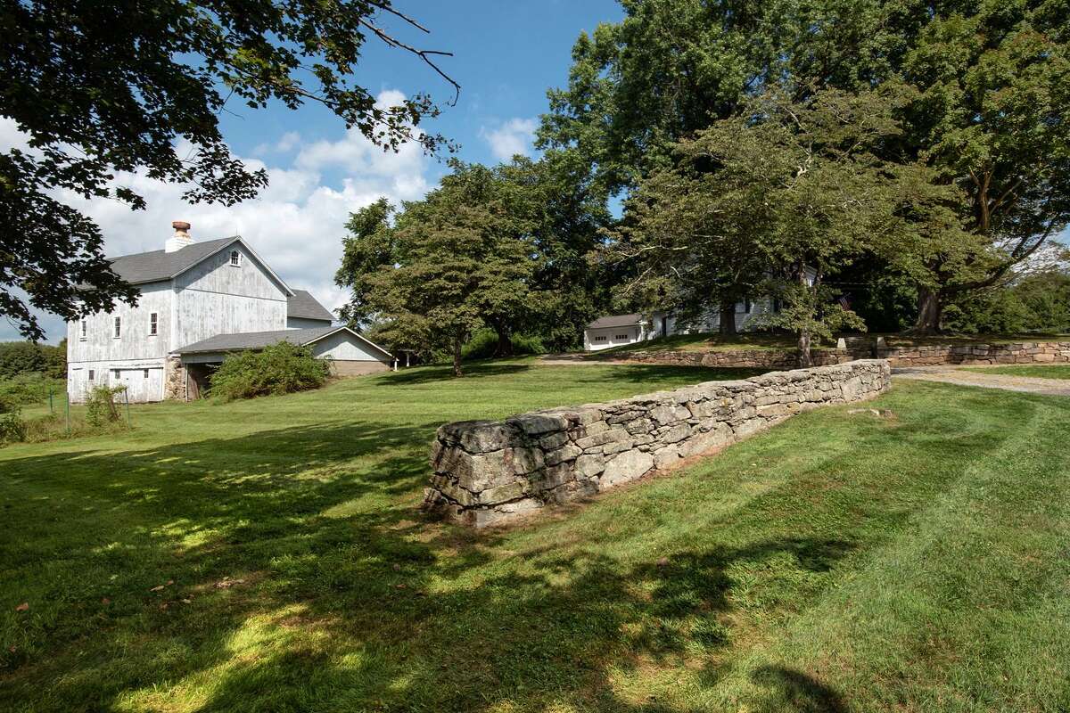 New England farmhouse a classic, outhouse and all