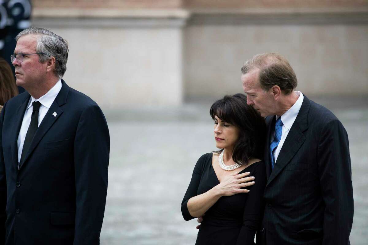 Thousands line train tracks to watch Bush funeral train to College Station