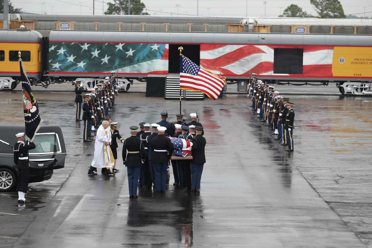 Thousands line train tracks to watch Bush funeral train to College Station