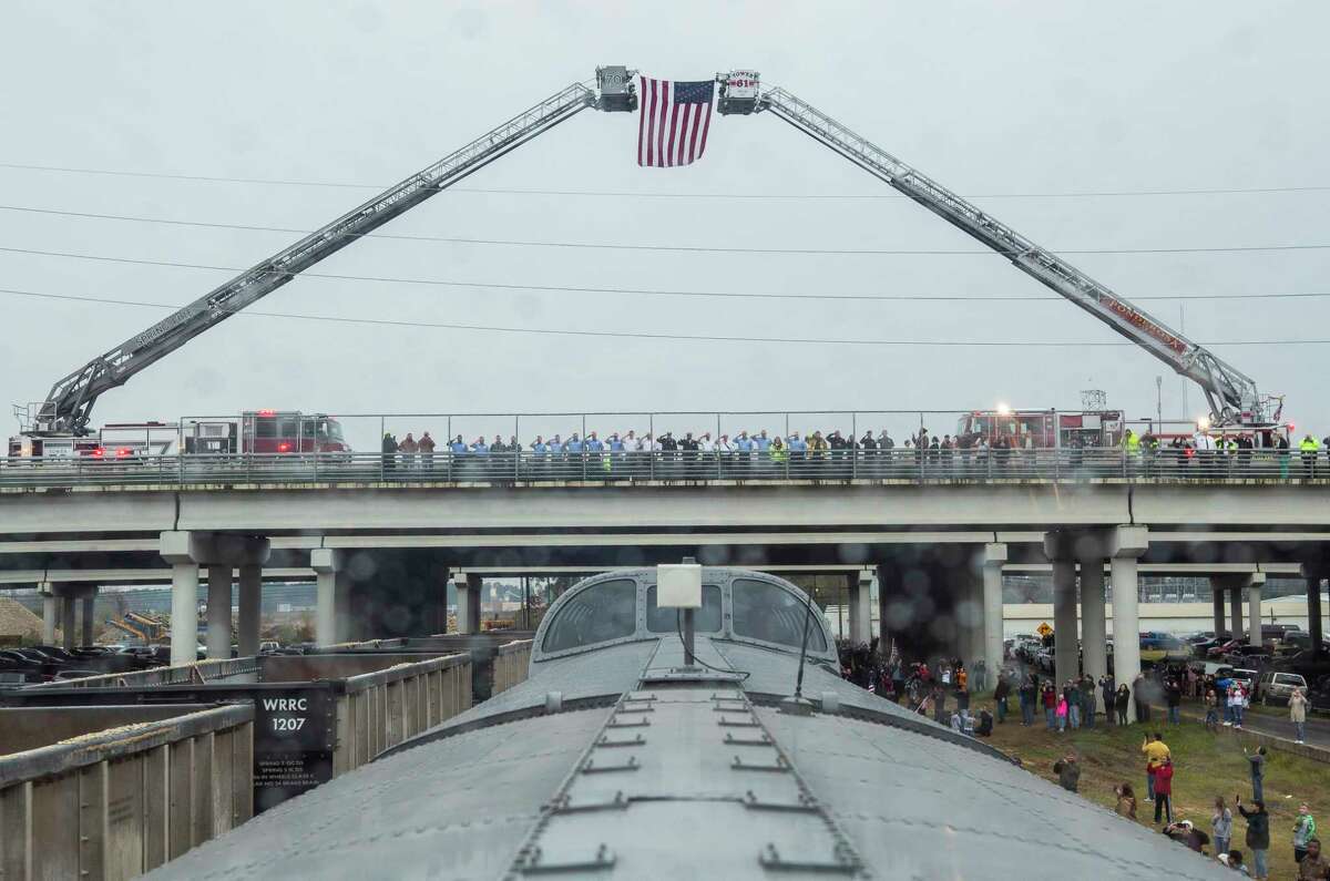Thousands line train tracks to watch Bush funeral train to College Station